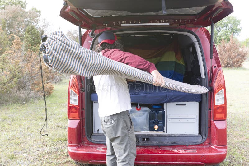 Rear View of a Man Taking a Surfboard Out of the Car Stock Photo ...
