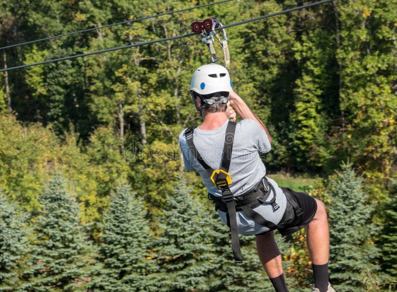 Rear View of a Man on a Zipline Going Down a Valley in Forest Editorial ...