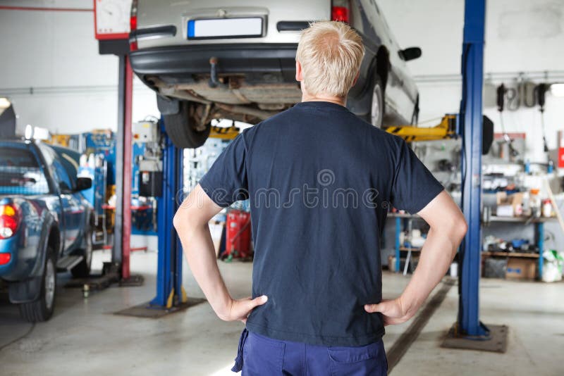 Rear View Mechanic Looking at Car Stock Image - Image of caucasian ...