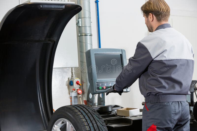 Rear View of Mid Adult Automobile Mechanic Working in Workshop Stock ...