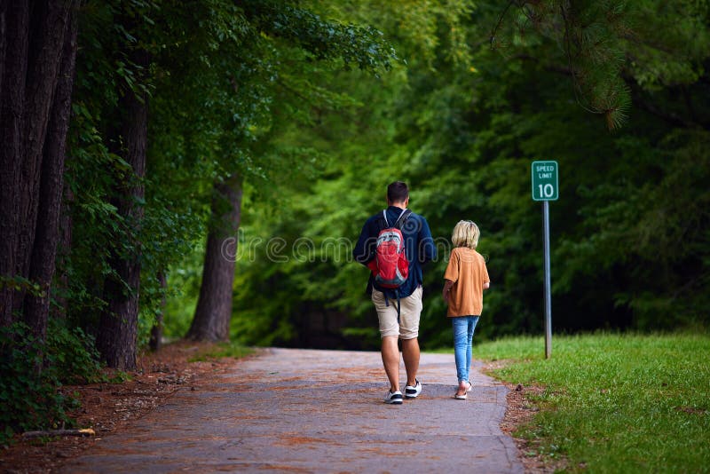 Rear View of People Walking Along the Trail in City Park Stock Photo ...