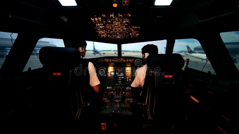 Back View of Pilots Sitting in Cockpit and Fly Passenger Plane Stock ...