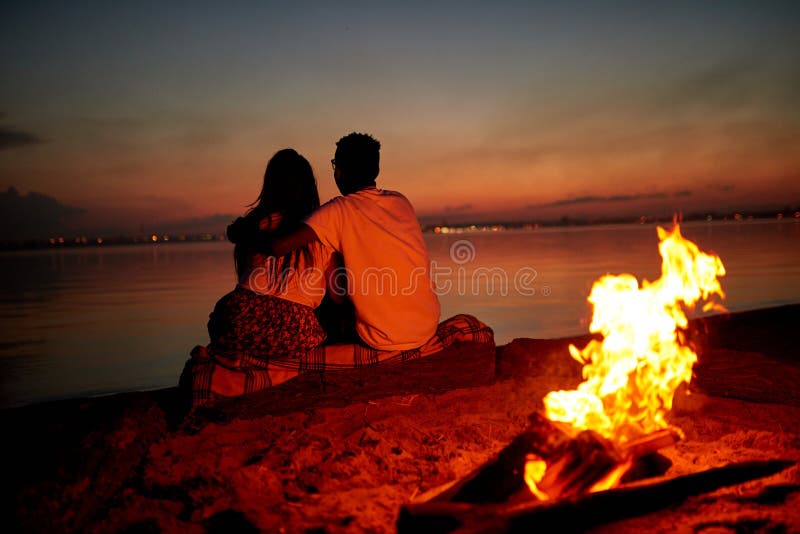Couple Cuddling Sitting On The Sand Of The Beach Stock Image Image Of