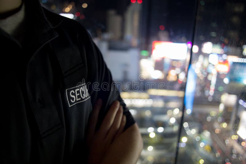 Security Guard Looking Down CityÂ full of Lights at Night Stock Photo ...