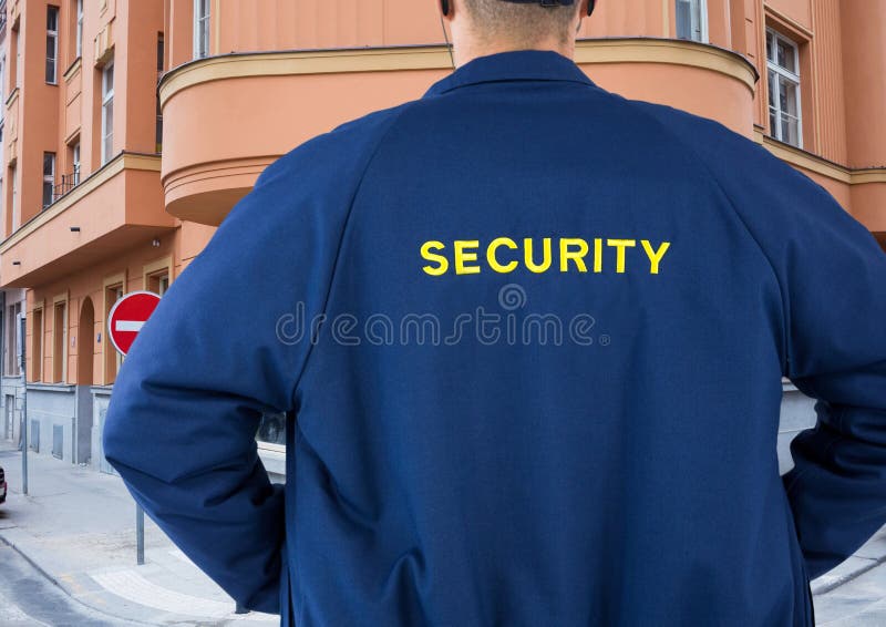 Rear View of Security Guard Standing in City Stock Image - Image of ...