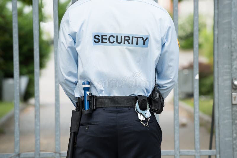 Security Guard Standing in Front of Gate Stock Photo - Image of ...