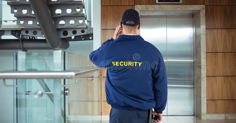 Rear View of Security Guard Waiting for Lift while Standing in Office ...
