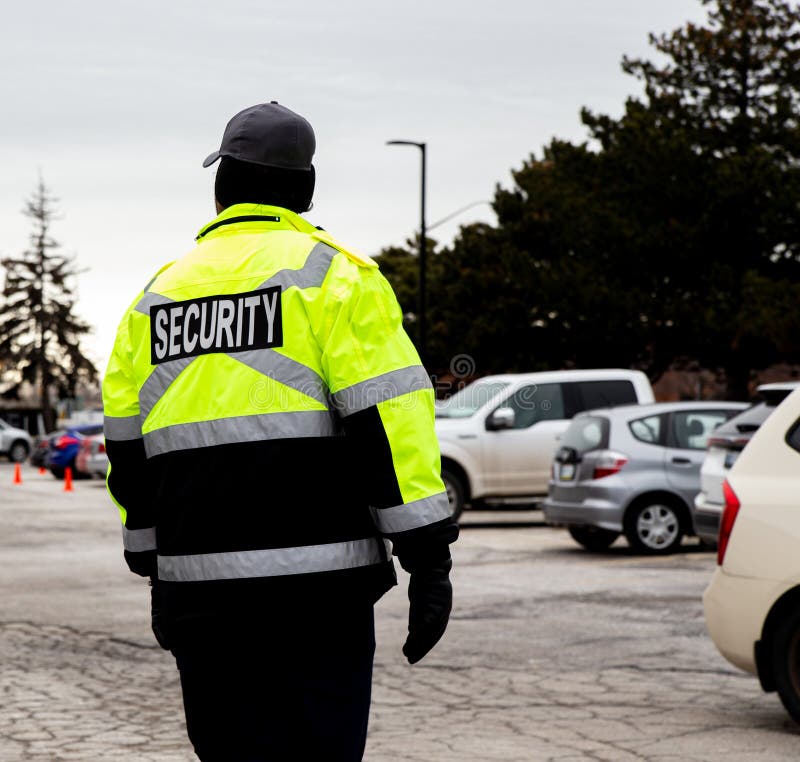 Rear View of a Security Guard Watching Over the Parking Area Stock ...