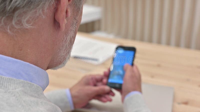 Rear View of Senior Old Man Browsing Internet on Smartphone Stock Image ...