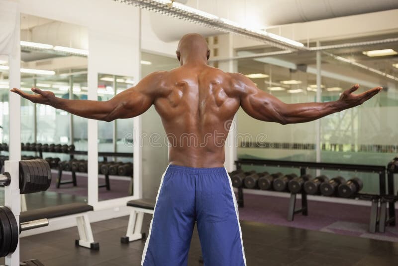 Rear View of a Shirtless Bodybuilder Stock Image - Image of standing ...