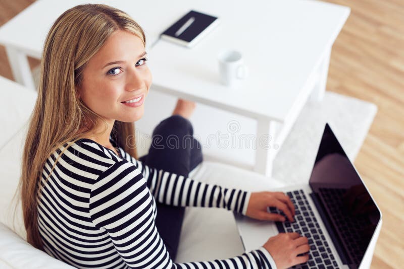 Rear View of Smiling Woman Using Laptop on Sofa Stock Image - Image of ...