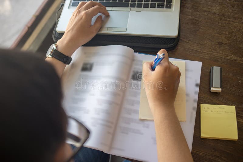 Rear View of Student Writing Sticky Note on Workbook Stock Image ...