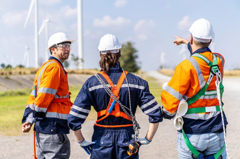 Rear View of Three Caucasian Engineers in Uniform and Hardhat Talk ...