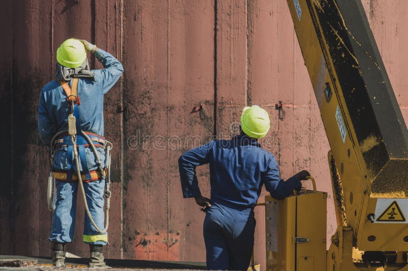 Rear View of Two Male Workers Working on a Construction Site Stock ...