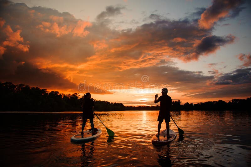 Rear View of Two People on Sup Boards Which Floating on the River at ...
