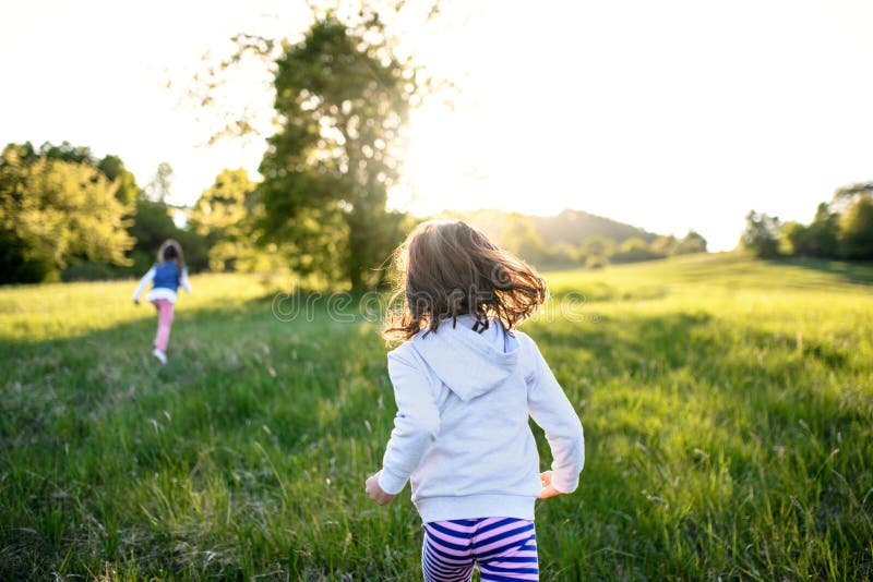 Rear View of Two Small Girls Running Outdoors in Spring Nature. Stock ...