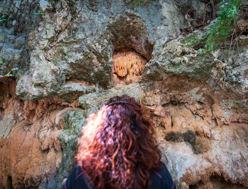 Unrecognizable Ginger Woman Observes the Stalactites Over the Rocks ...