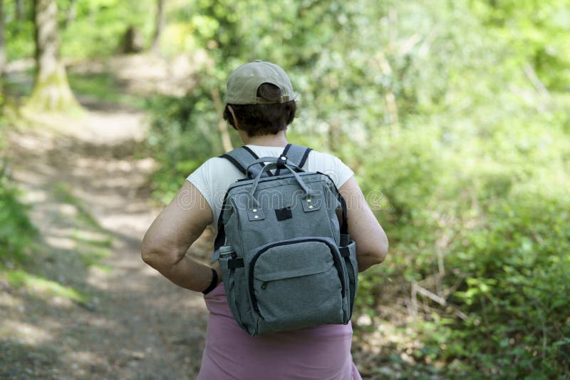 Rear View of a Woman with Backpack Walking on a Forest Trail Stock ...