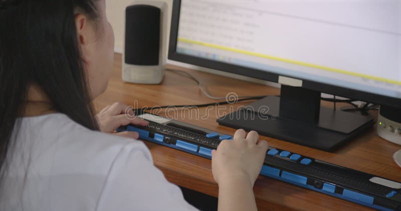Rear View of Woman with Blindness Disability Using Computer with ...