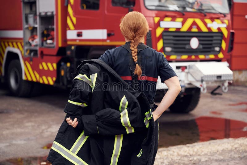 Rear View. Woman Firefighter in Uniform is at Work in Department Stock ...