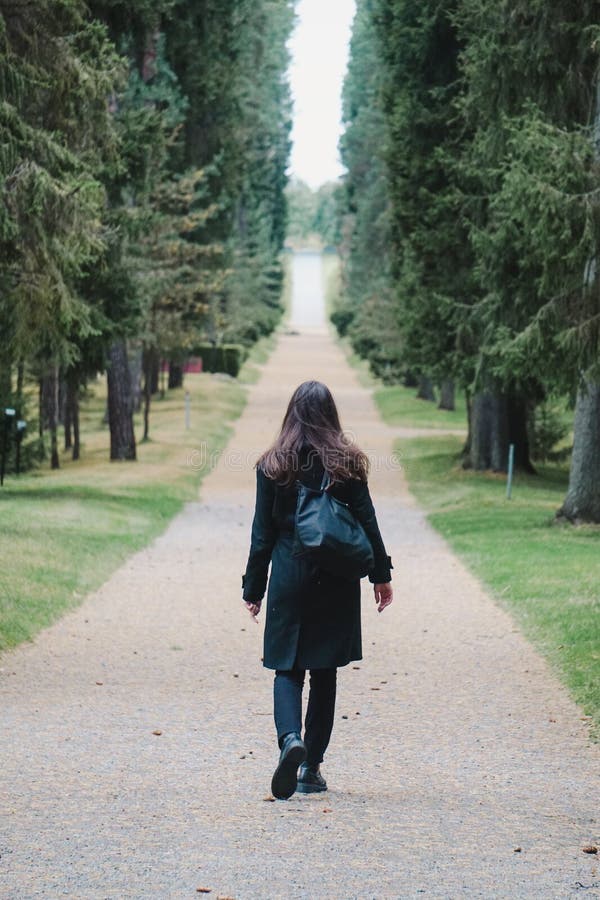 Rear View of Woman Walking on Footpath Amidst Trees Stock Image - Image ...