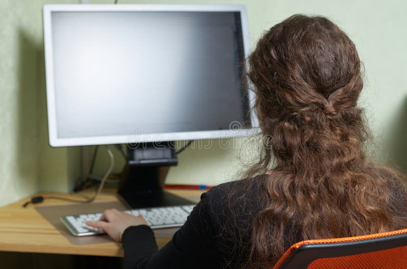 Rear View of a Woman Working at a Desktop Computer Stock Photo - Image ...