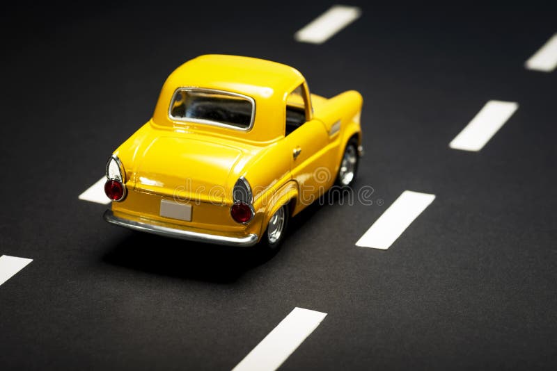 Rear View of a Yellow Toy Car on an Asphalt Road Stock Image - Image of ...