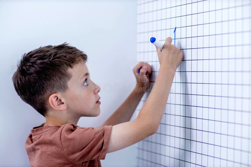 Rear View of Young Boy Solving Math Problems on White Board Stock Image ...