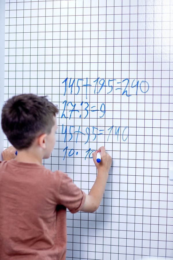 Rear View of Young Boy Solving Math Problems on White Board Stock Photo ...