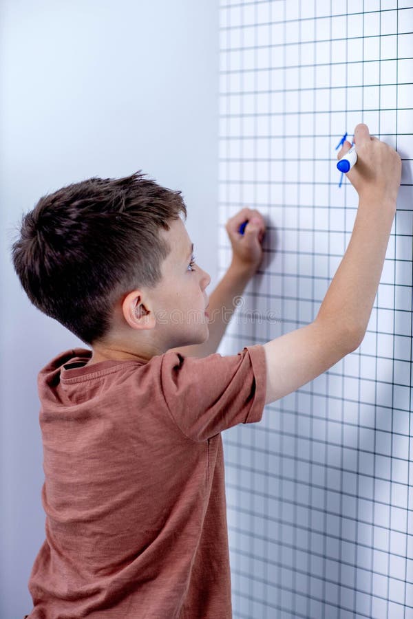 Rear View of Young Boy Solving Math Problems on White Board Stock Image ...