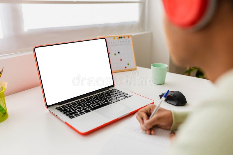 Rear View of Young Boy Taking Notes while Looking at Laptop Screen ...