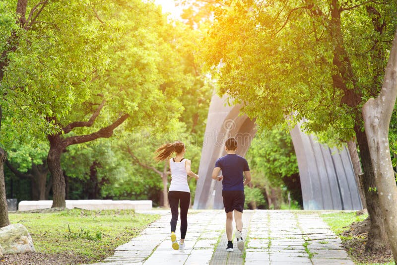 Young Couple Jogging and Running in Park Stock Photo - Image of couple ...