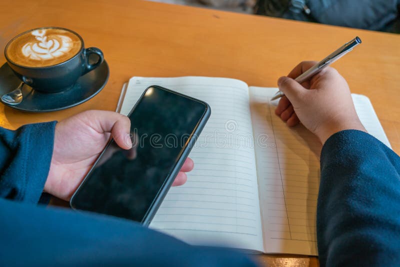 Writing Notes and Using Smartphone Stock Photo - Image of books ...