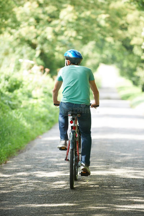 Rear View of Young Man Enjoying Cycle Ride in Countryside Stock Image ...