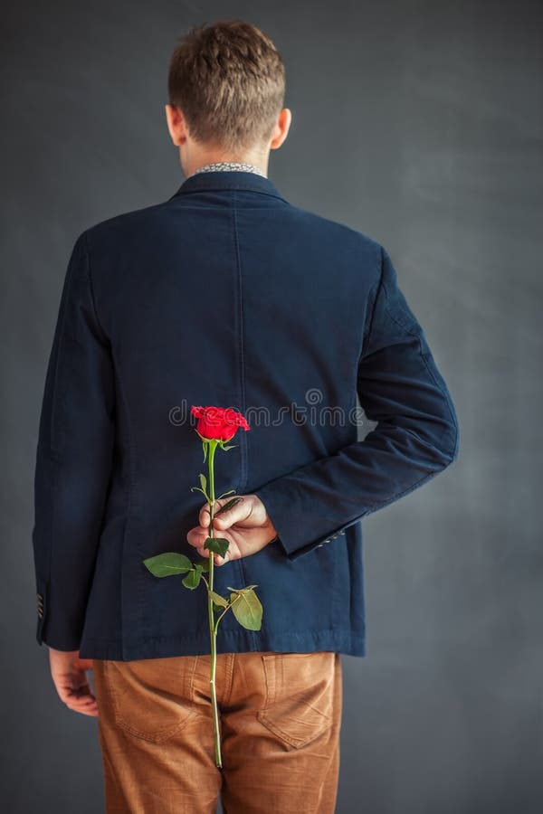 Rear View of Young Man Holding Red Rose Behind His Back Stock Image ...