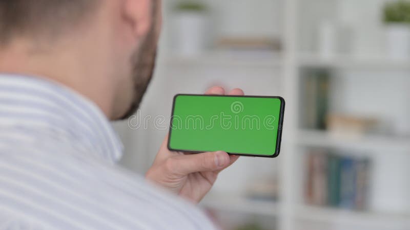 Rear View of Young Man Watching Smartphone with Chroma Key Screen Stock ...