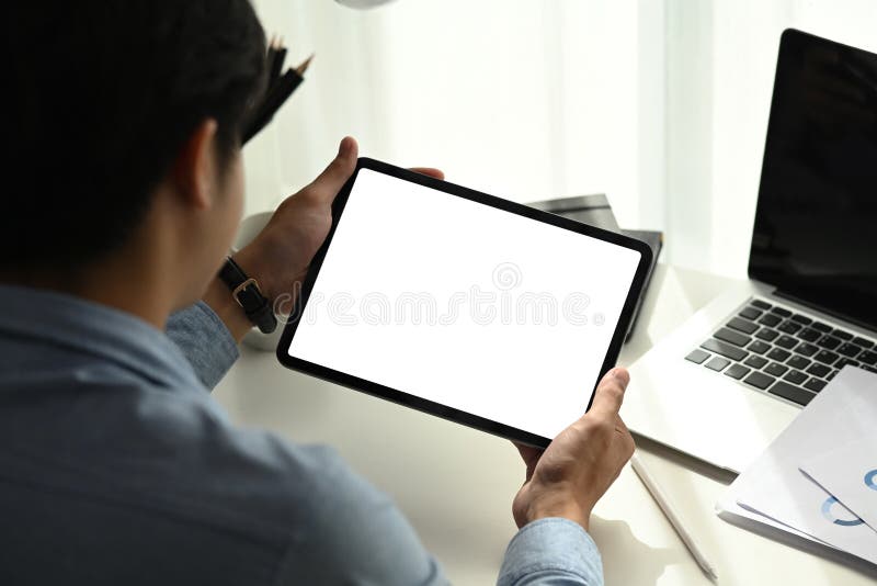 Rear View of Young Man Working on Tablet Portable Electronic Device and ...