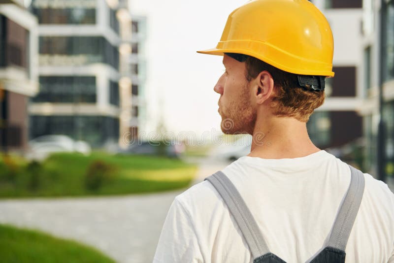 Rear View. Young Man Working in Uniform at Construction at Daytime ...