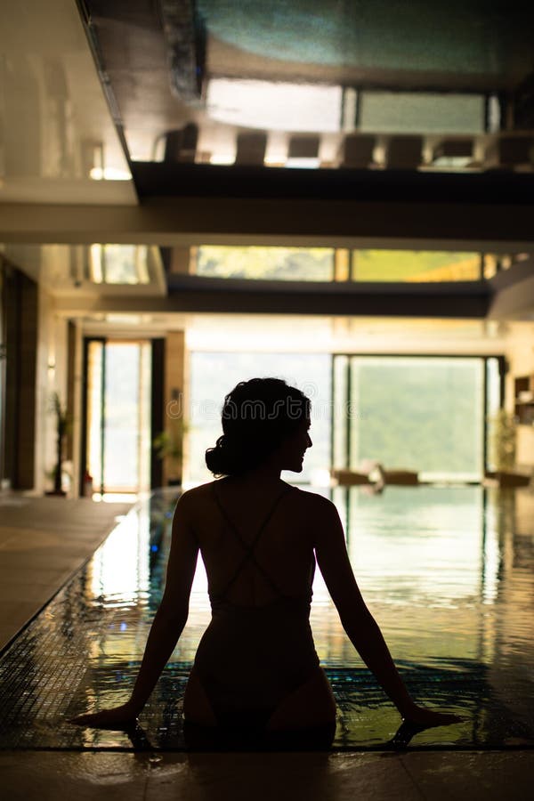 Rear View of Young Woman Relaxing on the Poolside Stock Image - Image ...