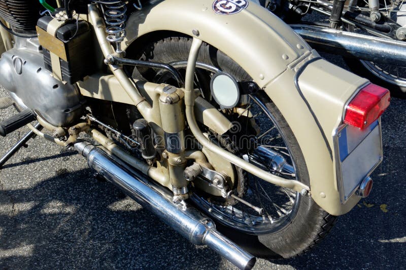 Rear Wheel and Chromed Exhaust Pipe of a Classic English Motorcycle ...