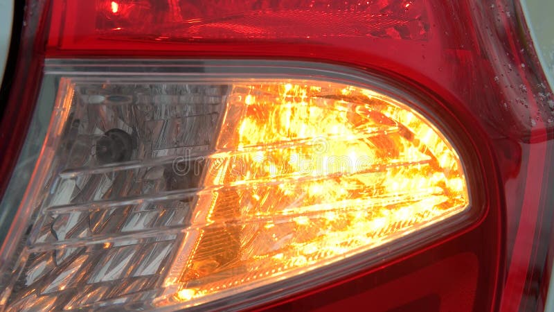 Blinking on a Rear Light of a Silver Modern Car in a Suburban Area ...