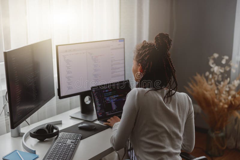 Rear of Young Woman Looking at Computer Screen while Working ...