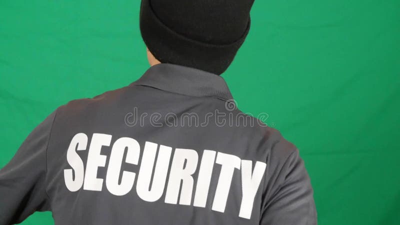 Security Guard Standing on the Green Background. Stock Video - Video of ...