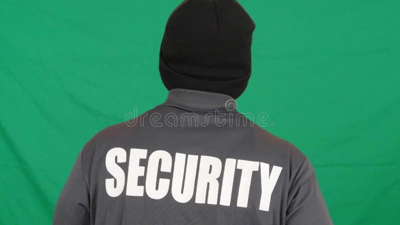 Security Guard Standing on the Green Background. Stock Video - Video of ...
