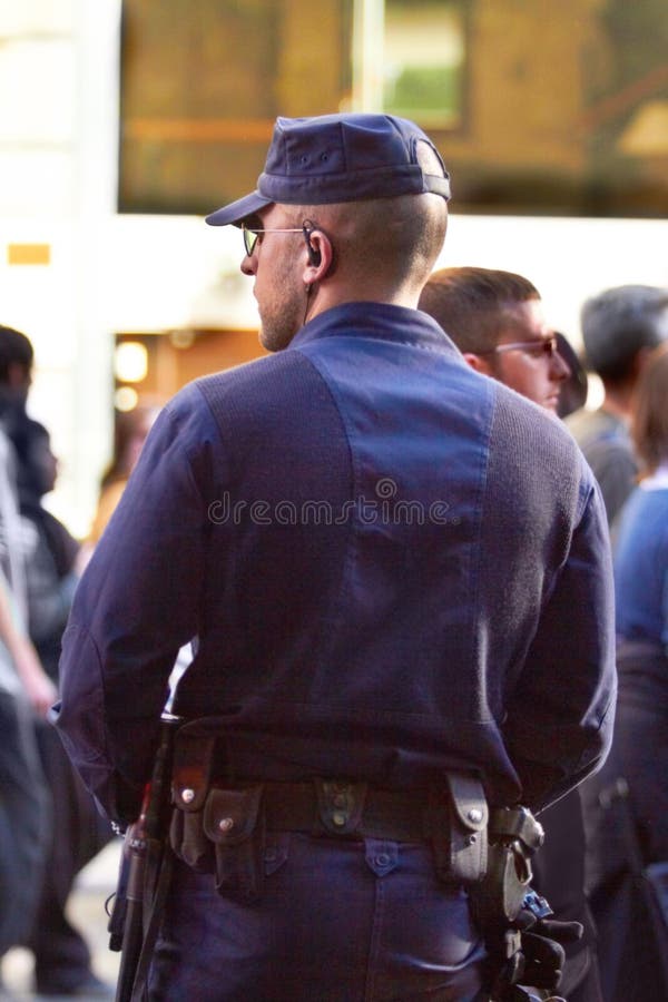 Hes on Crowd Control. Rearview Shot of a Policeman Doing Crowd Control ...