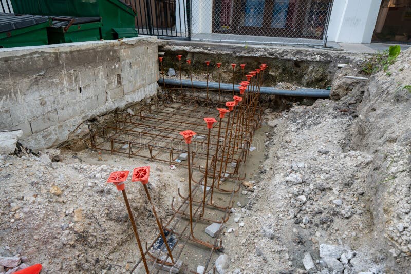 Rebar with Orange Safety Caps Protruding from Poured Concrete Footings ...