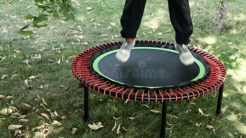 Rebounding on a Mini Trampoline in a Backyard Stock Footage - Video of ...