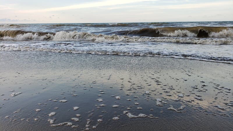 Receding Waves on a Sandy Beach with Bubbles Stock Photo - Image of ...