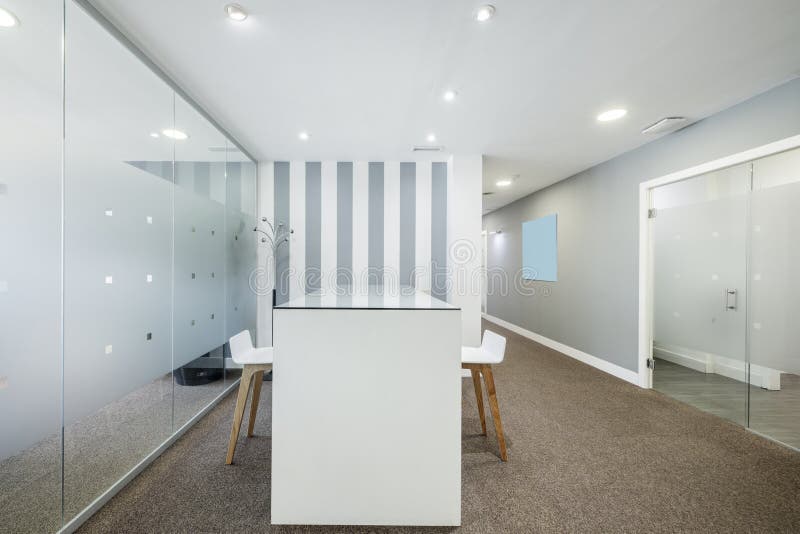 Reception Desk of an Office Office with Glass Partitions and Carpeted ...