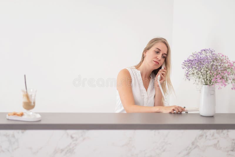 Receptionist in a Beauty Salon Talking To a Client on the Phone. Stock ...